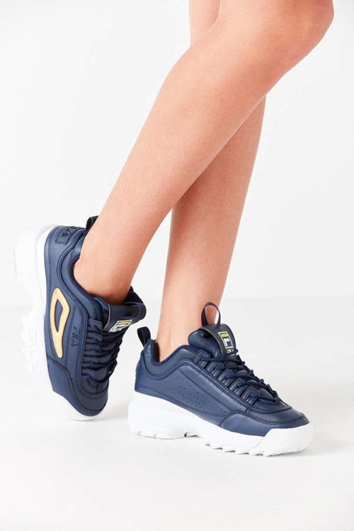 Fila Disruptor II Offered In Black And Gold At Urban Outfitters